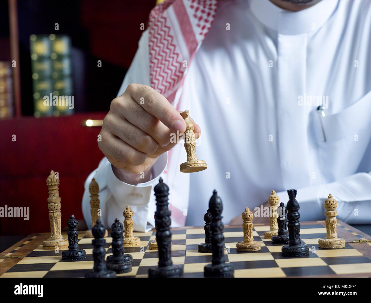 An Arab man playing chess at his desk Stock Photo - Alamy