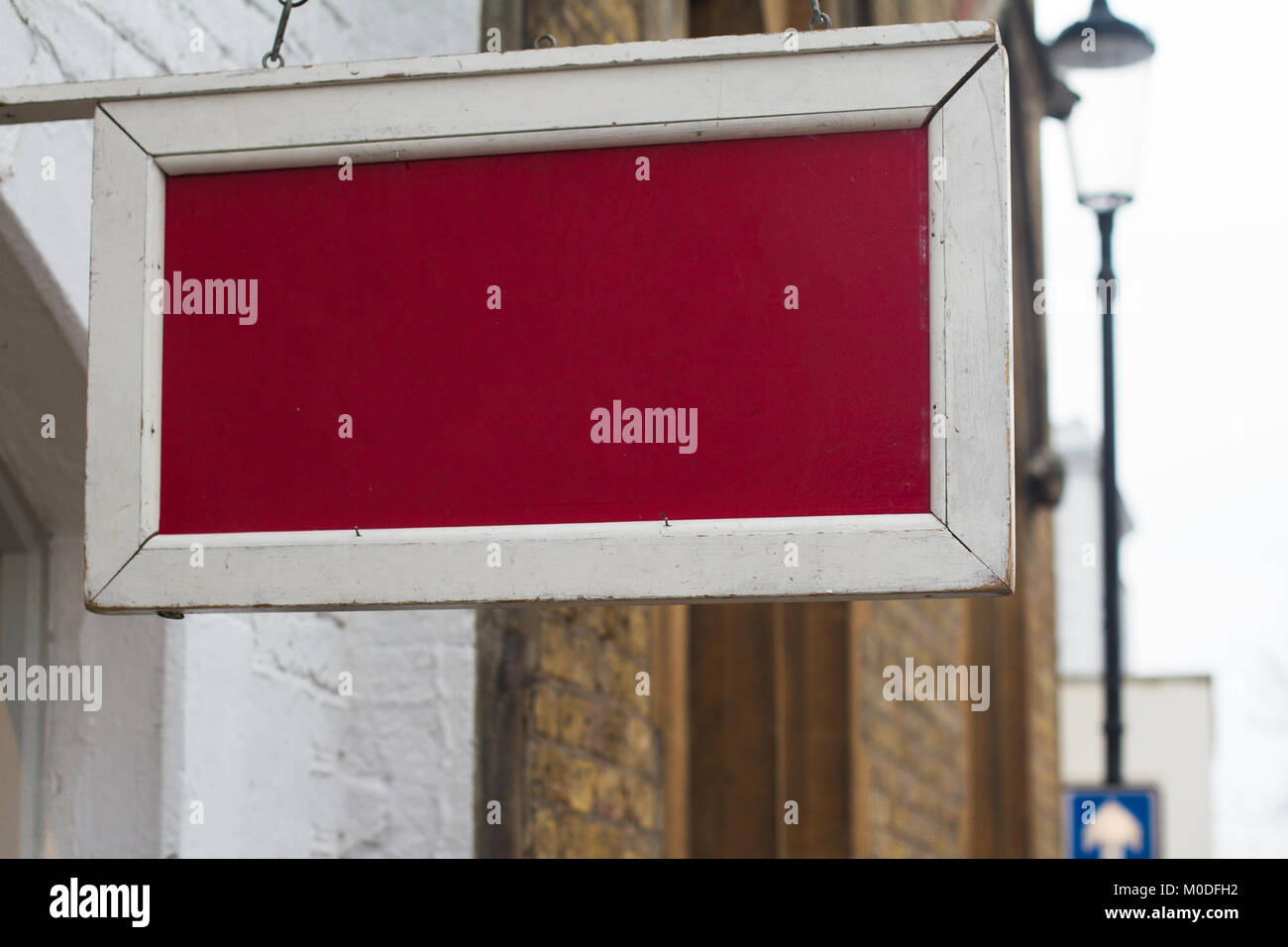 Horizontal side view of empty red square signage on a British building ...