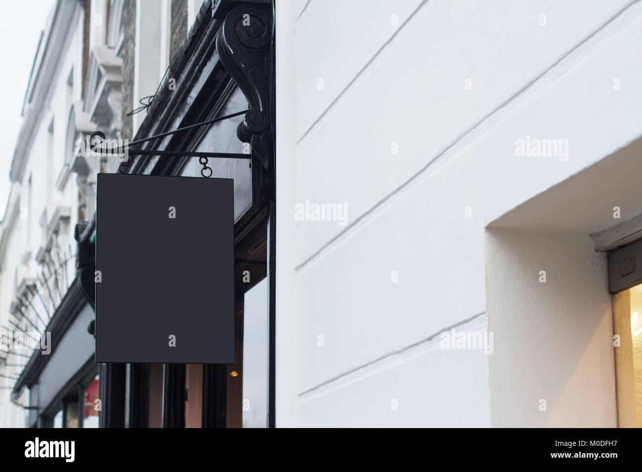 Horizontal side view of empty black square signage on a British ...