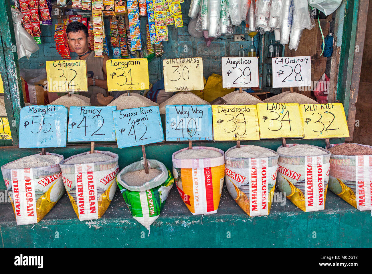 Filipino vendor offers twelve varieties of white rice at the farmer's ...