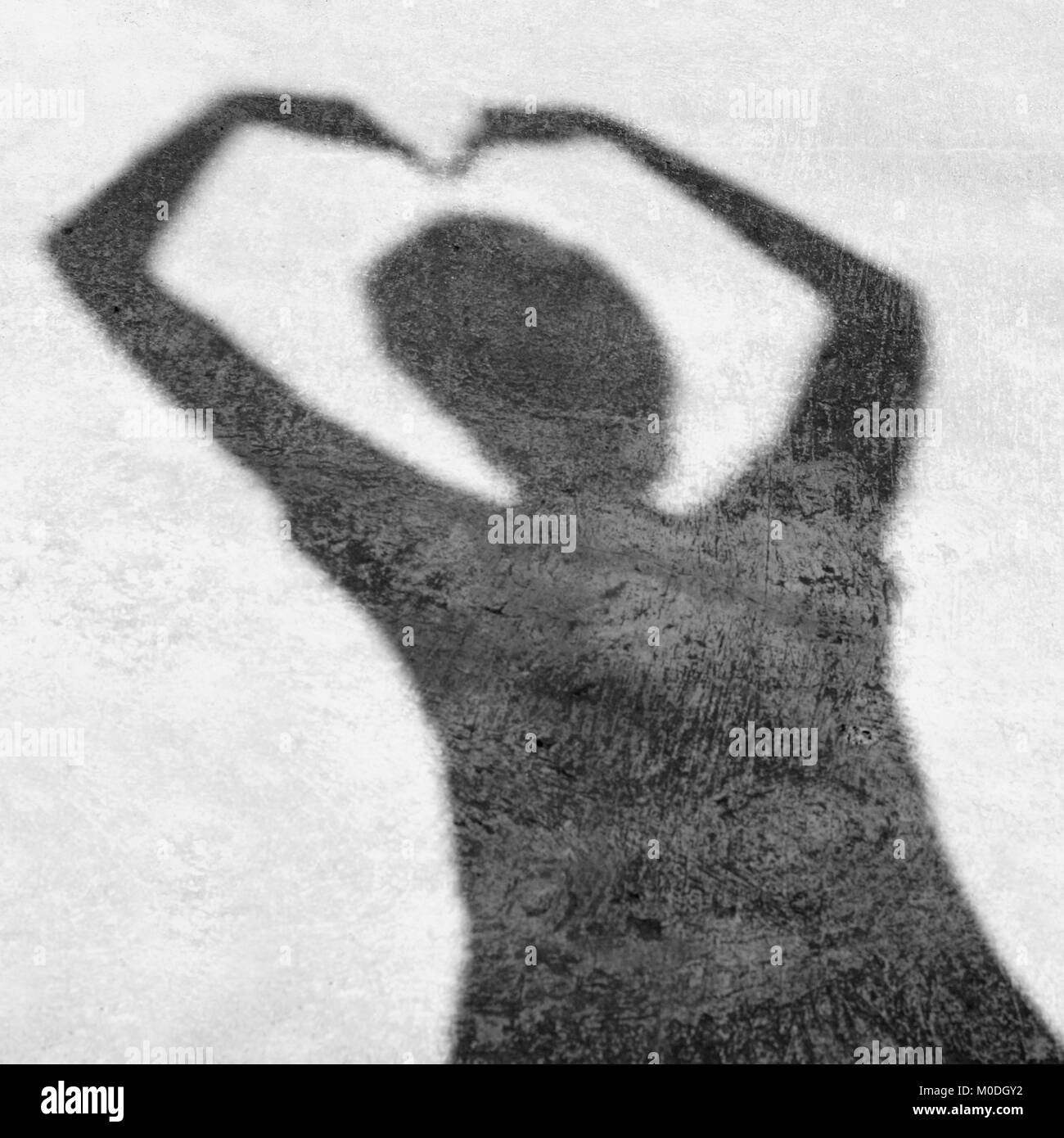 Shadow of love shape body on the ground texture Stock Photo - Alamy