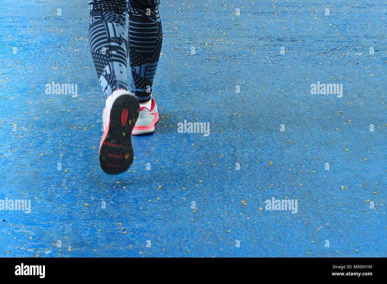 Girl running on walkway Stock Photo - Alamy