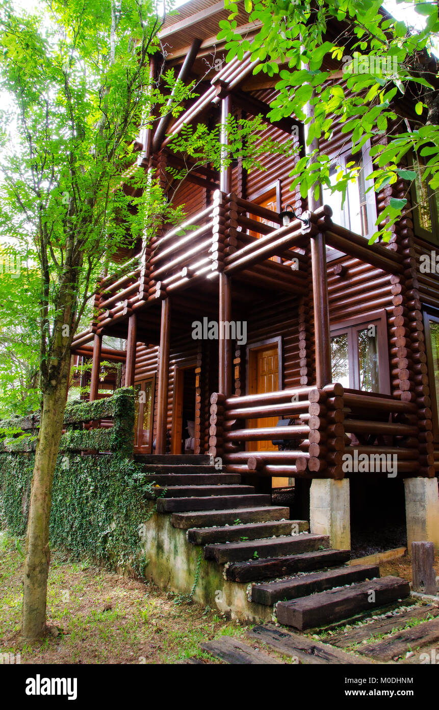 Log house - Cozy log house amongst green environment Stock Photo - Alamy