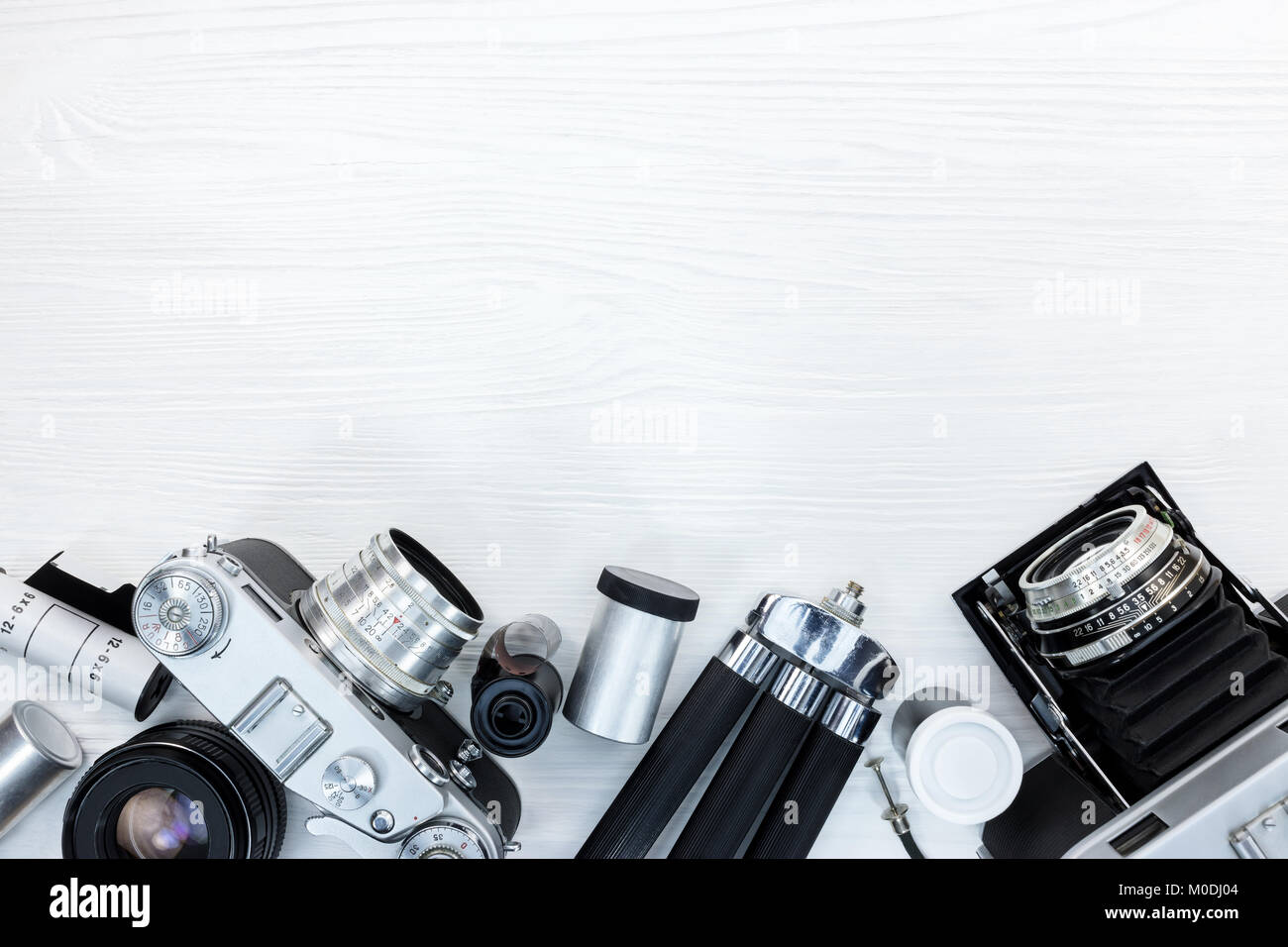 vintage retro photo cameras, tripod, negative film rolls and lens on ...