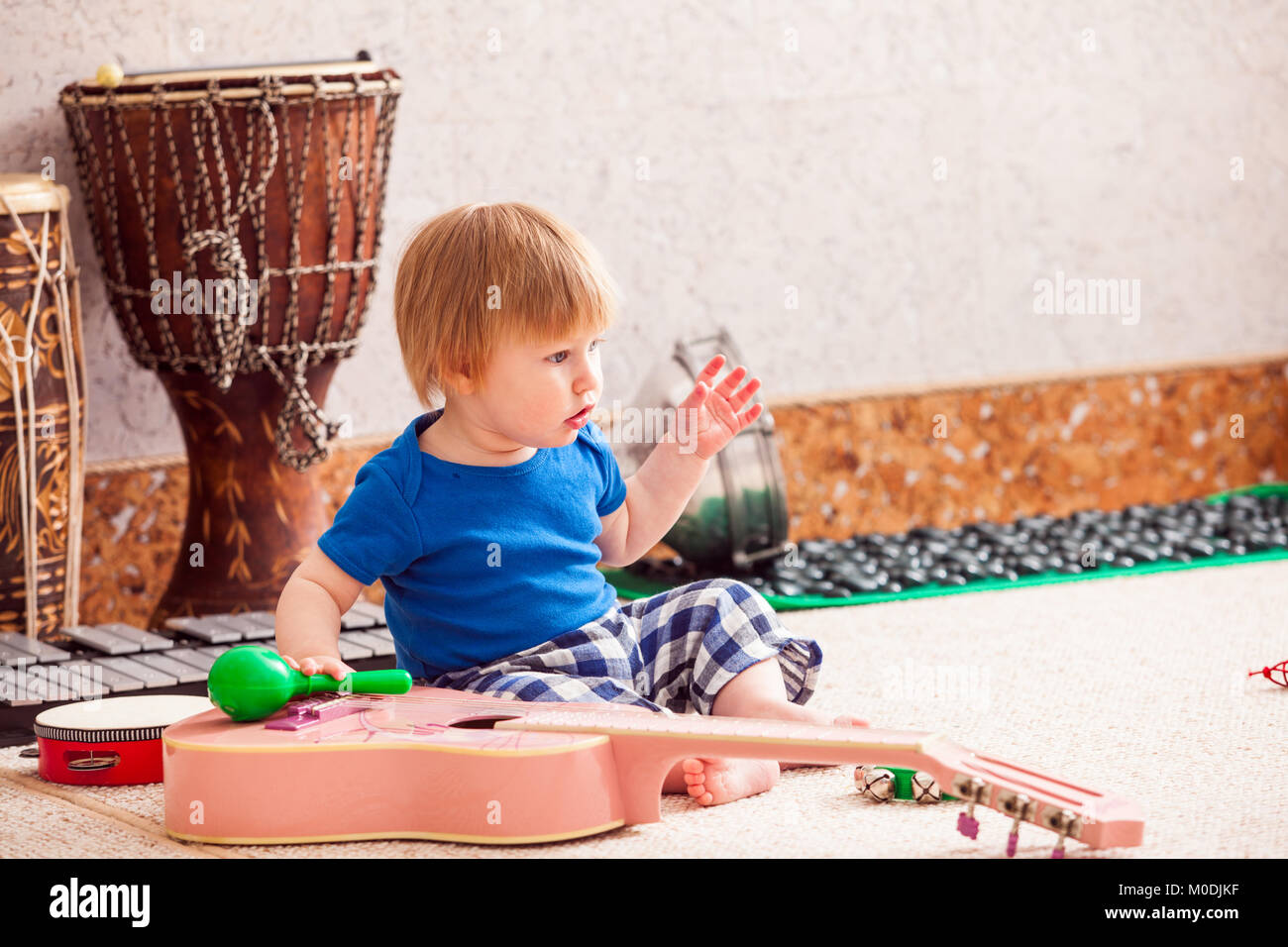 Boy with musical instruments Stock Photo - Alamy