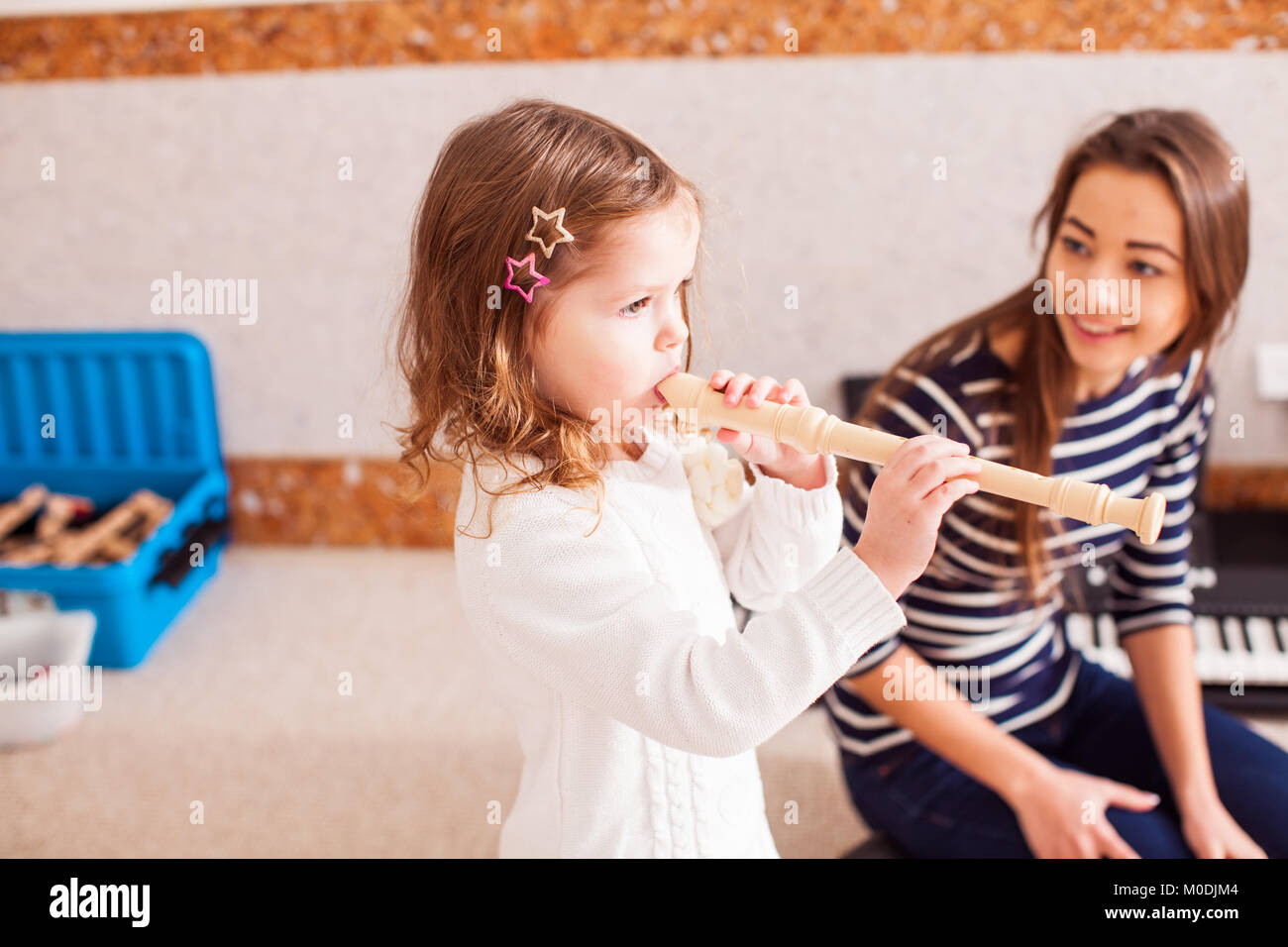 The little girl to play on the flute Stock Photo - Alamy
