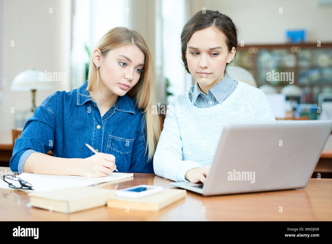 Doing University Assignment with Friend Stock Photo - Alamy