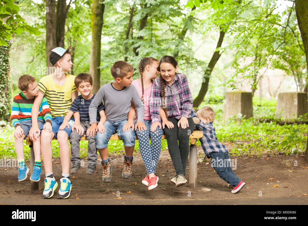Kids on the bench Stock Photo - Alamy
