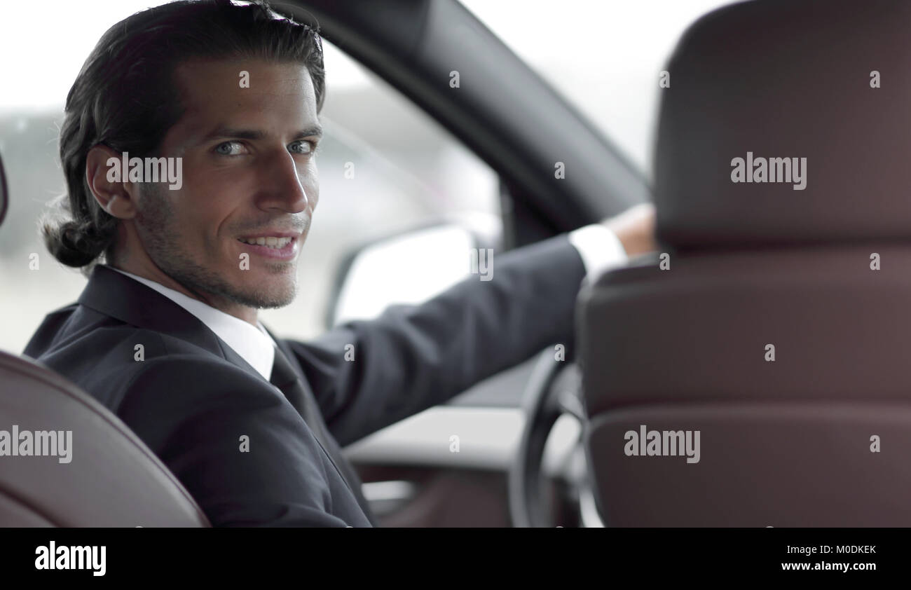 man sitting behind the wheel of a car Stock Photo - Alamy
