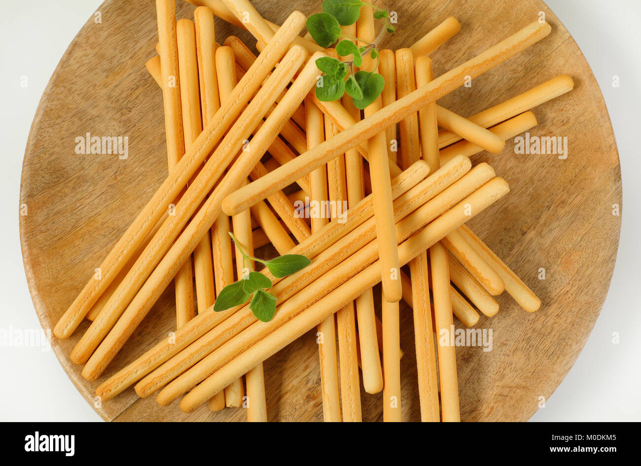 crispy bread sticks on round wooden cutting board - close up Stock ...
