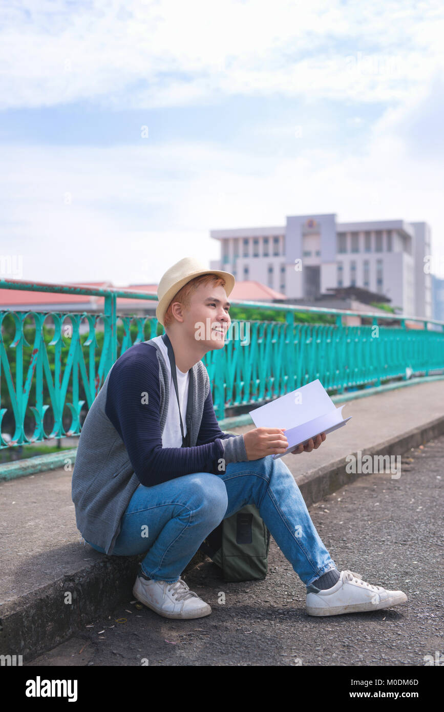 Asian student walking reading hi-res stock photography and images - Alamy