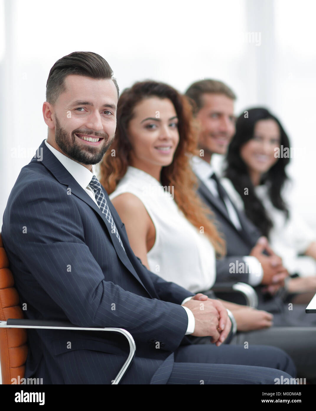group of business people sitting at the desktop Stock Photo - Alamy