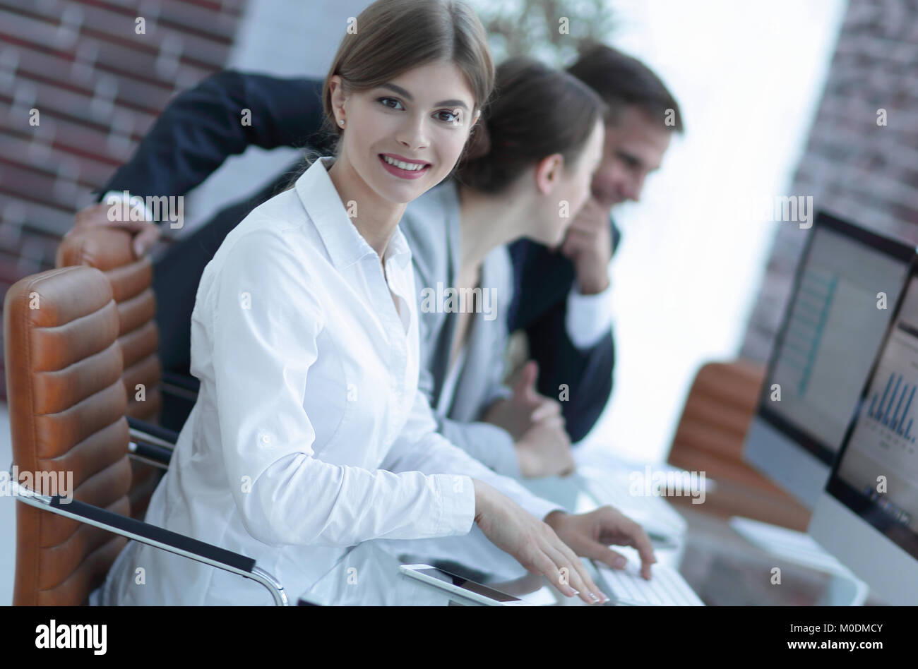 young employee sitting at a Desk Stock Photo - Alamy