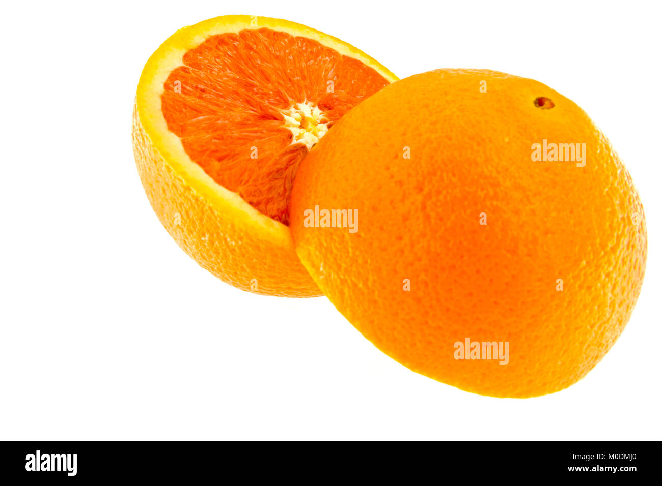 Close up of fresh sunkist orange cut half isolated on white background ...