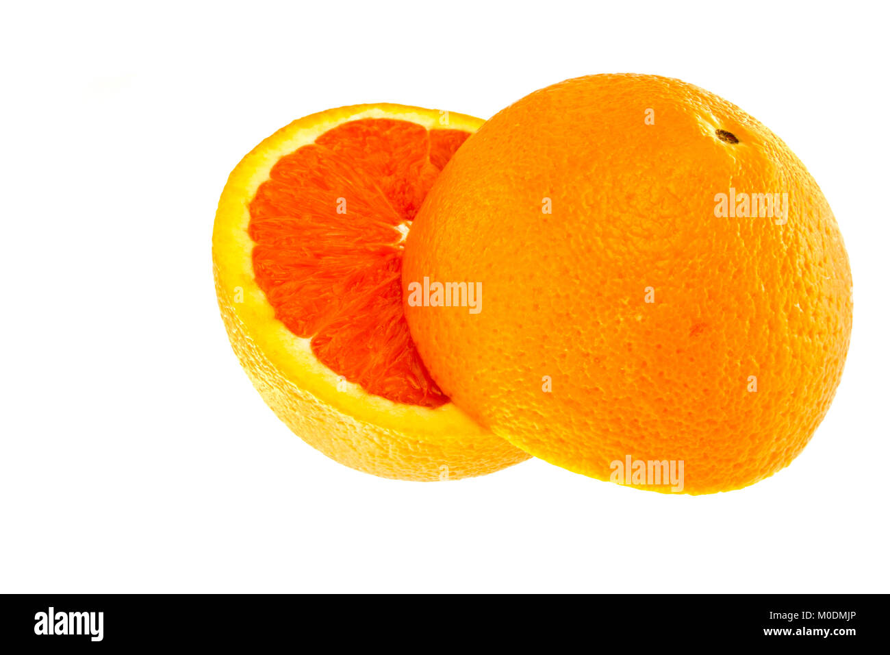 Close up of fresh sunkist orange cut half isolated on white background ...