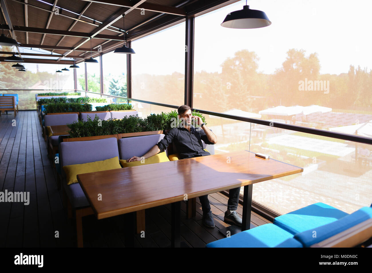 Prosperous man using smartphone for conversation an power bank a Stock ...