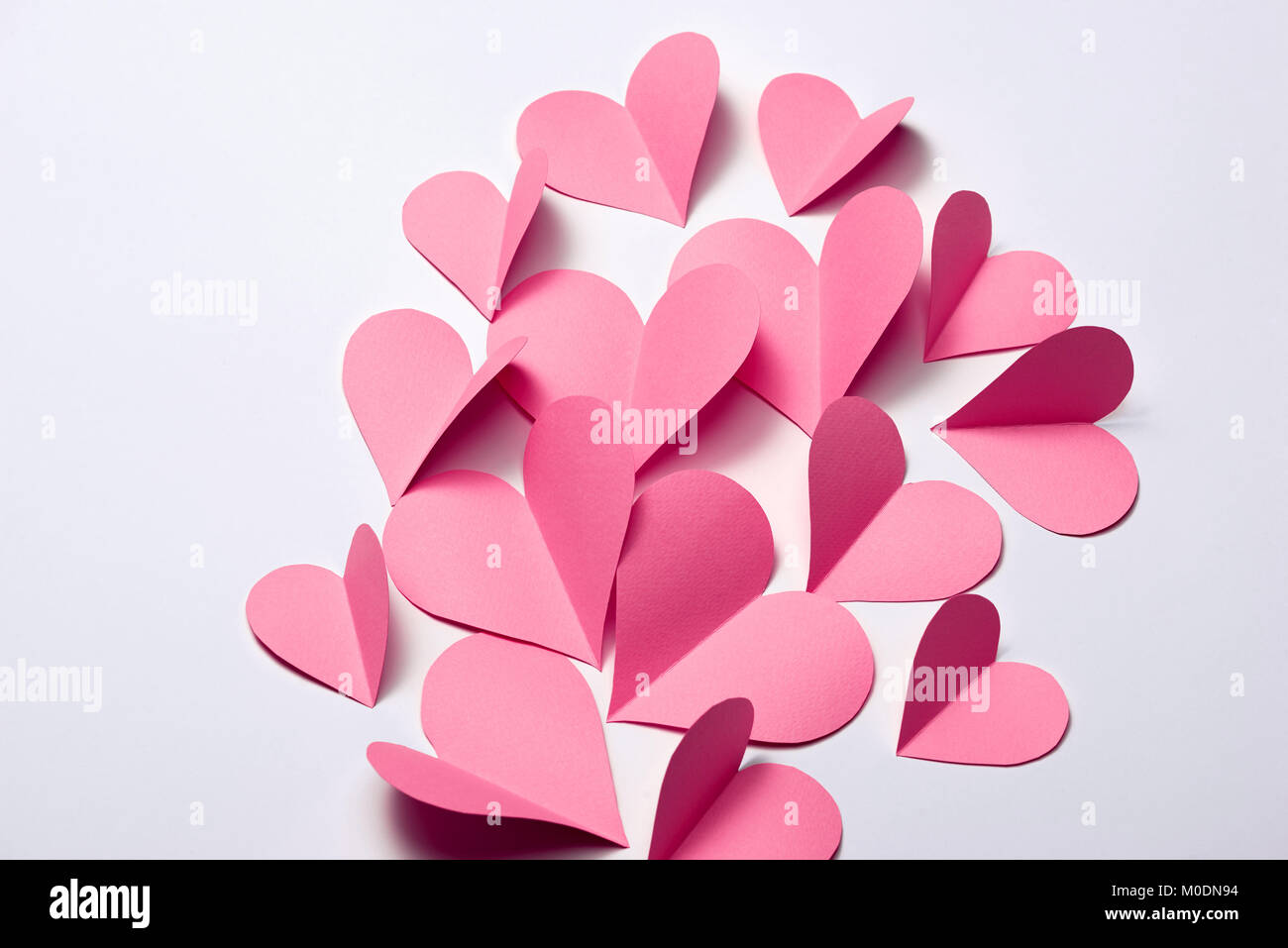 Beautiful pink paper hearts on white paper background Stock Photo - Alamy