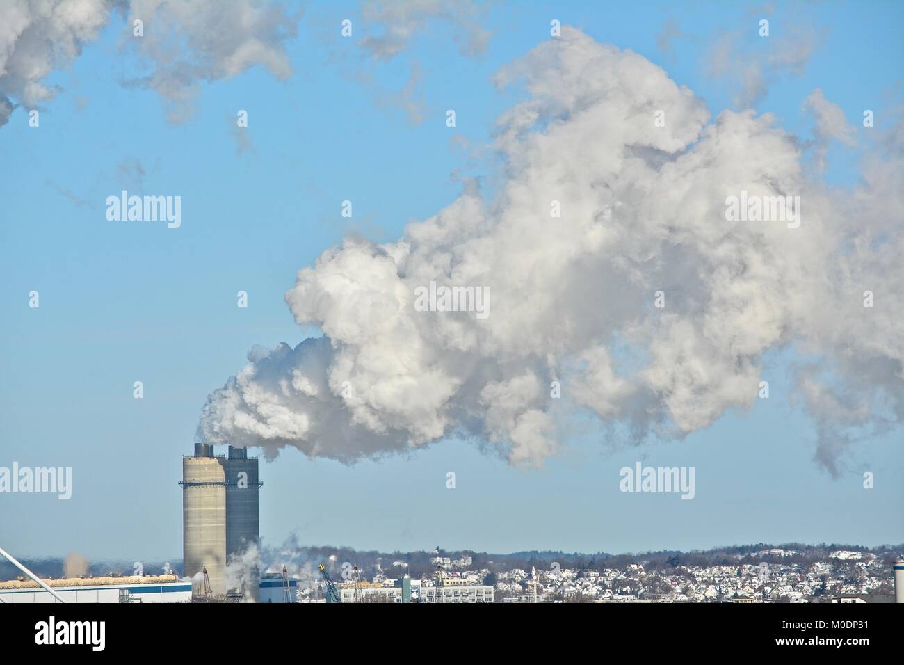 Industrial Smoke Stacks in Greater Boston spewing smoke/steam against a ...