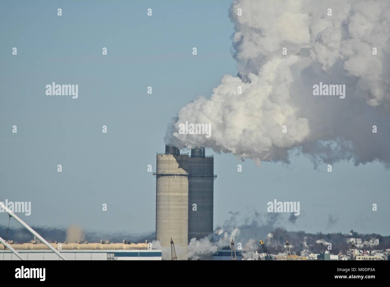 Industrial Smoke Stacks in Greater Boston spewing smoke/steam against a ...