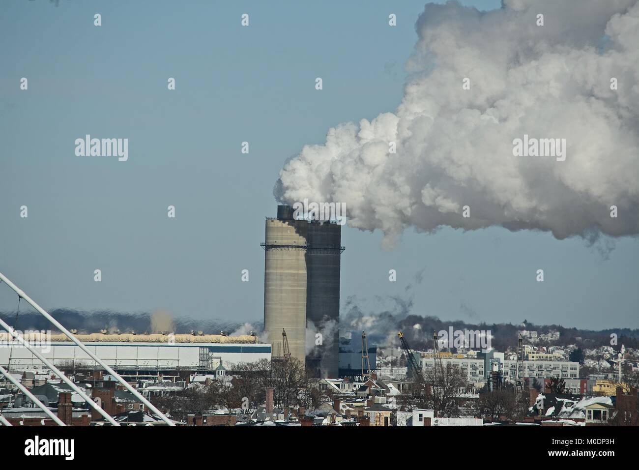 Industrial Smoke Stacks in Greater Boston spewing smoke/steam against a ...