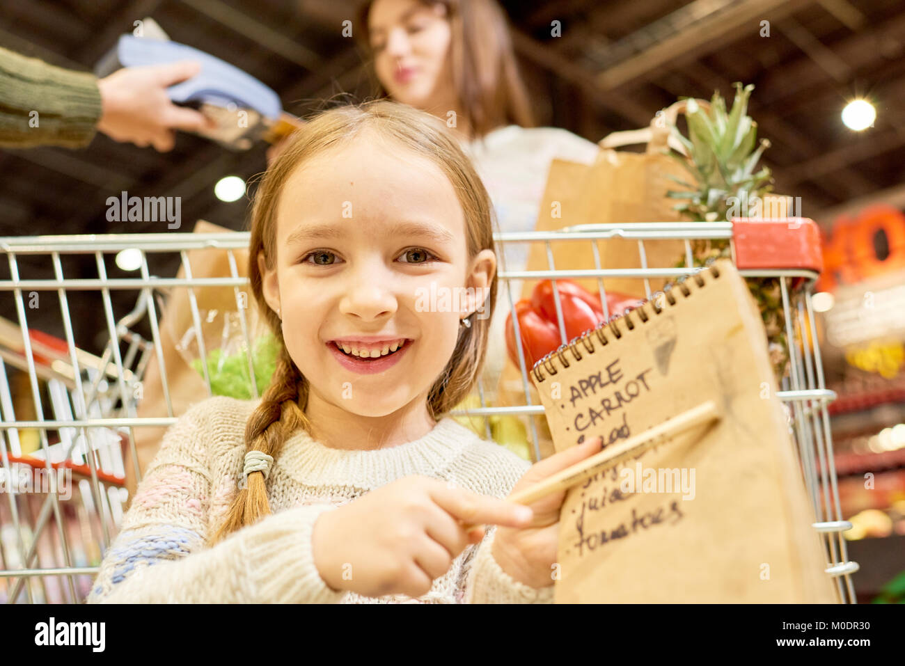 Happy Little Girl Holding Shopping List Stock Photo - Alamy