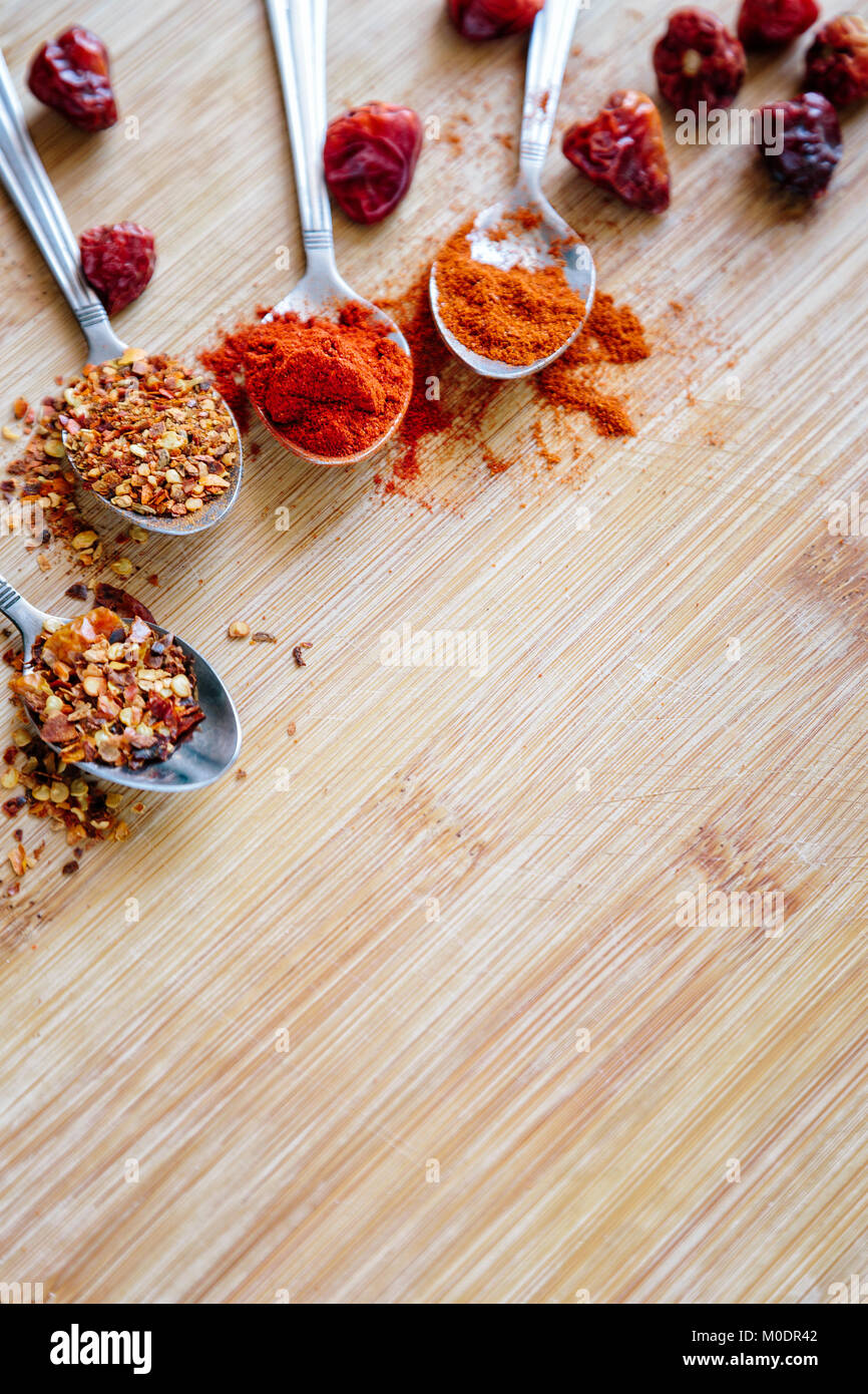 Various hot spices on a wooden background Stock Photo - Alamy