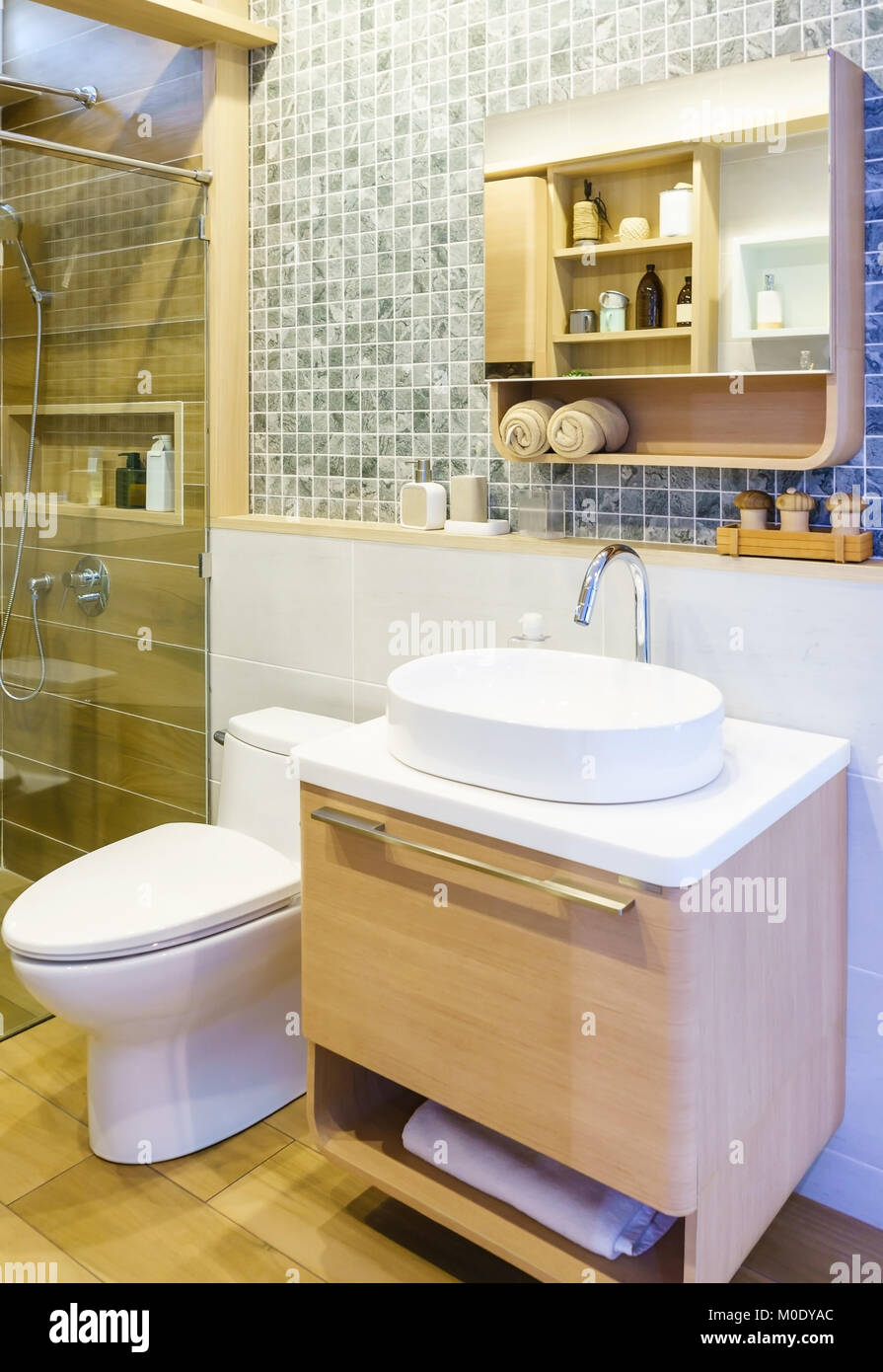 Modern spacious bathroom with bright tiles with toilet and sink. Side ...