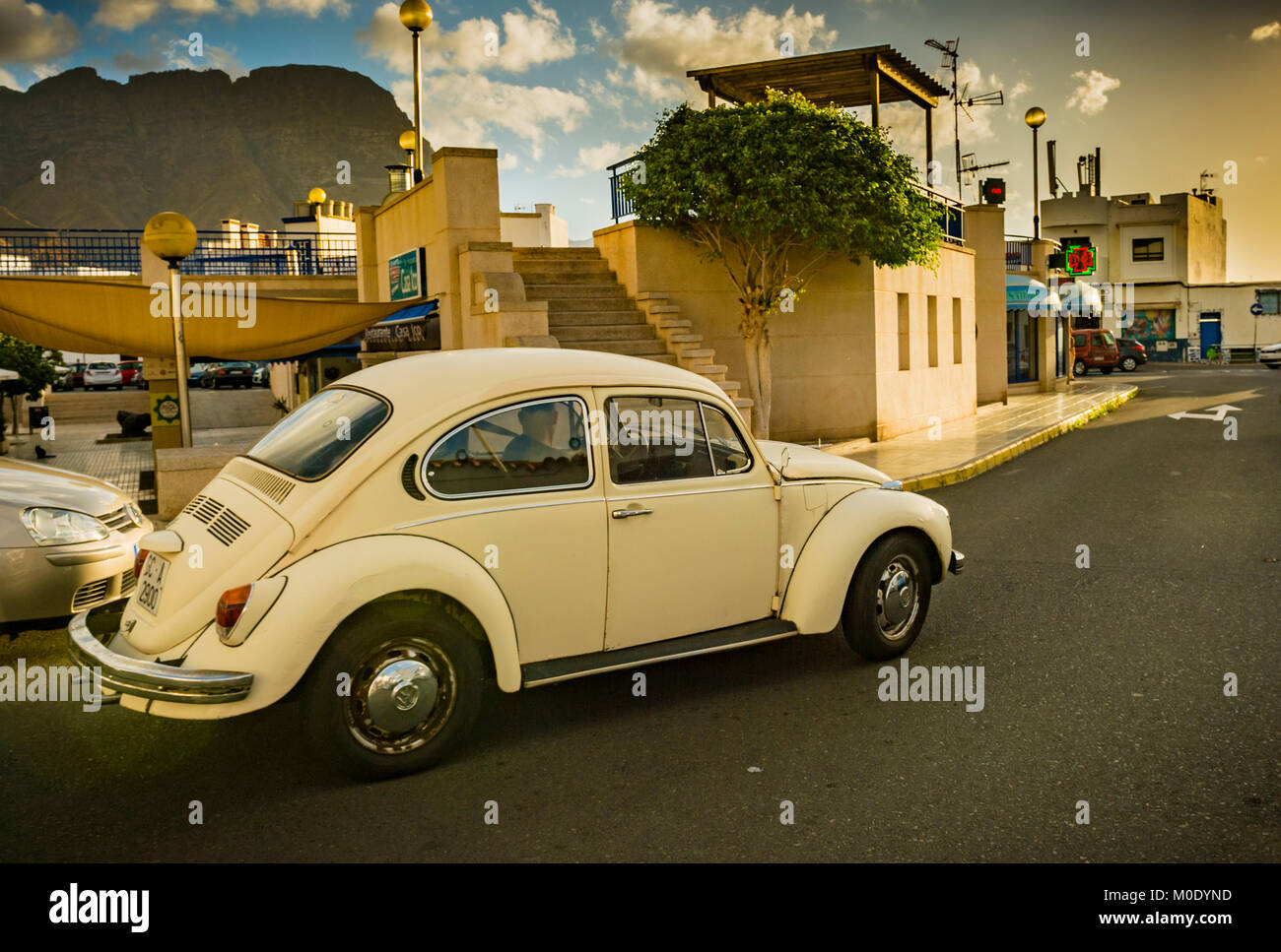 An vintage car driving around a corner in an old town Stock Photo - Alamy