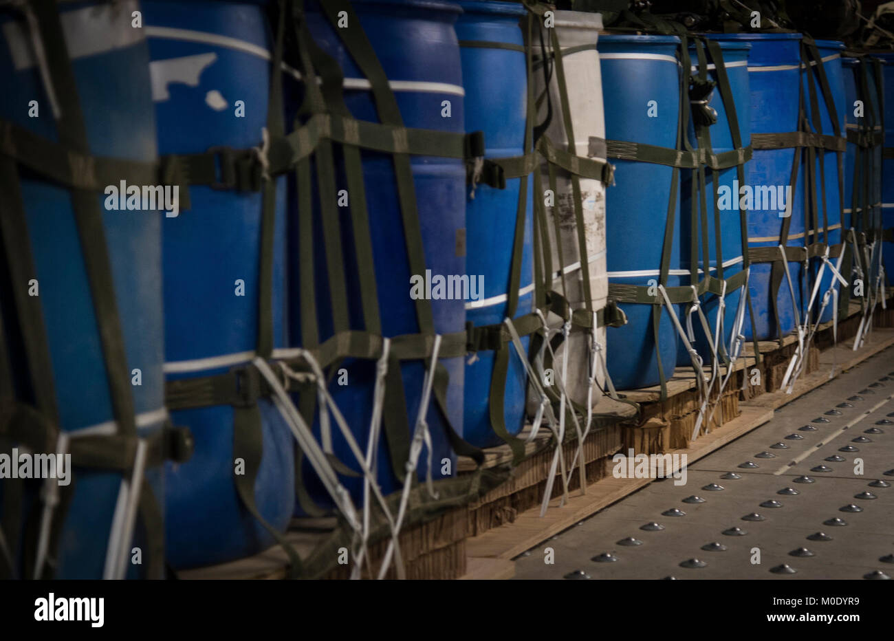 Heavy cargo pallets are packed with four 600-pound water barrels at the ...