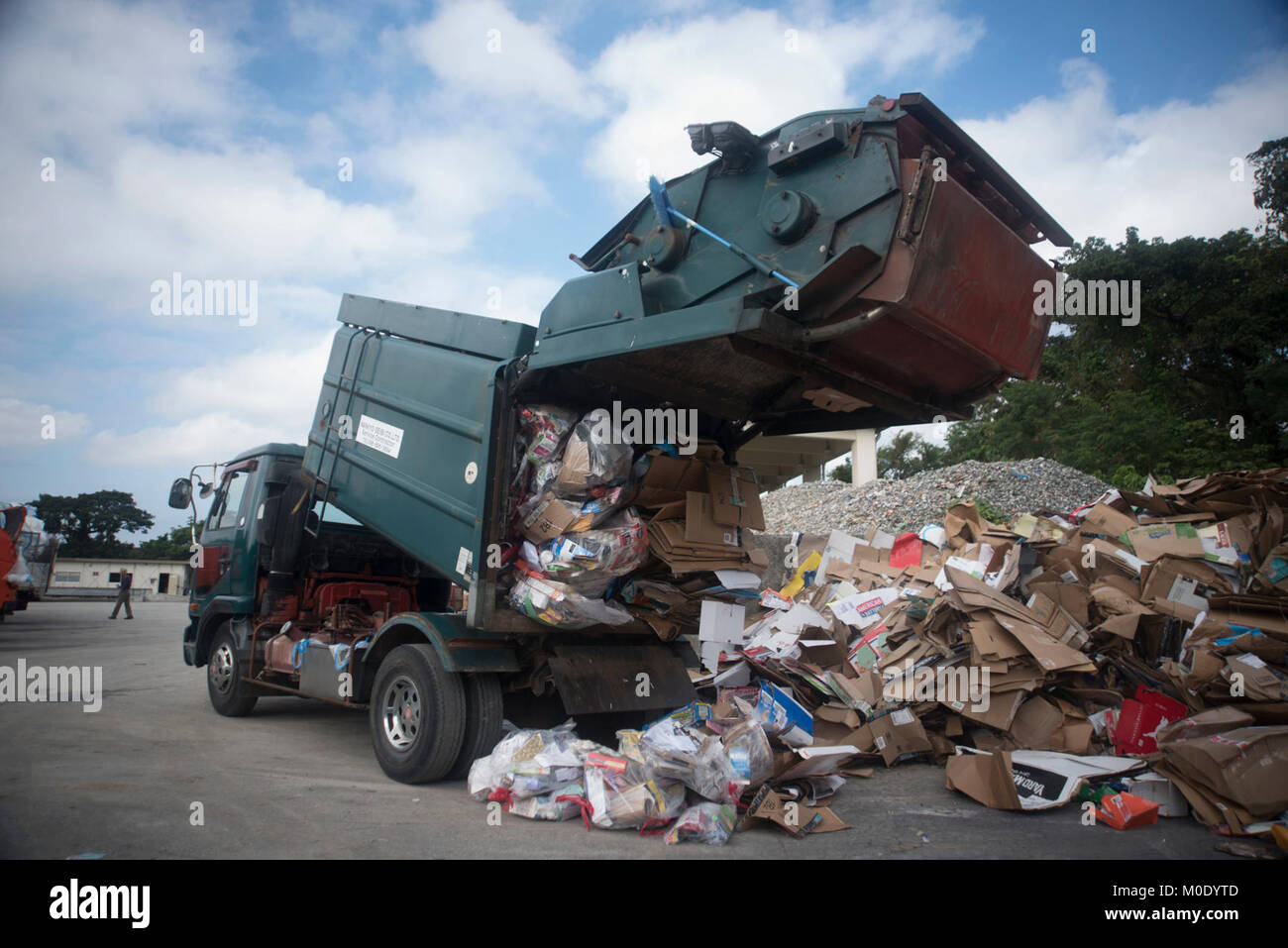 A garbage truck unloads paper and cardboard in a mass cardboard ...