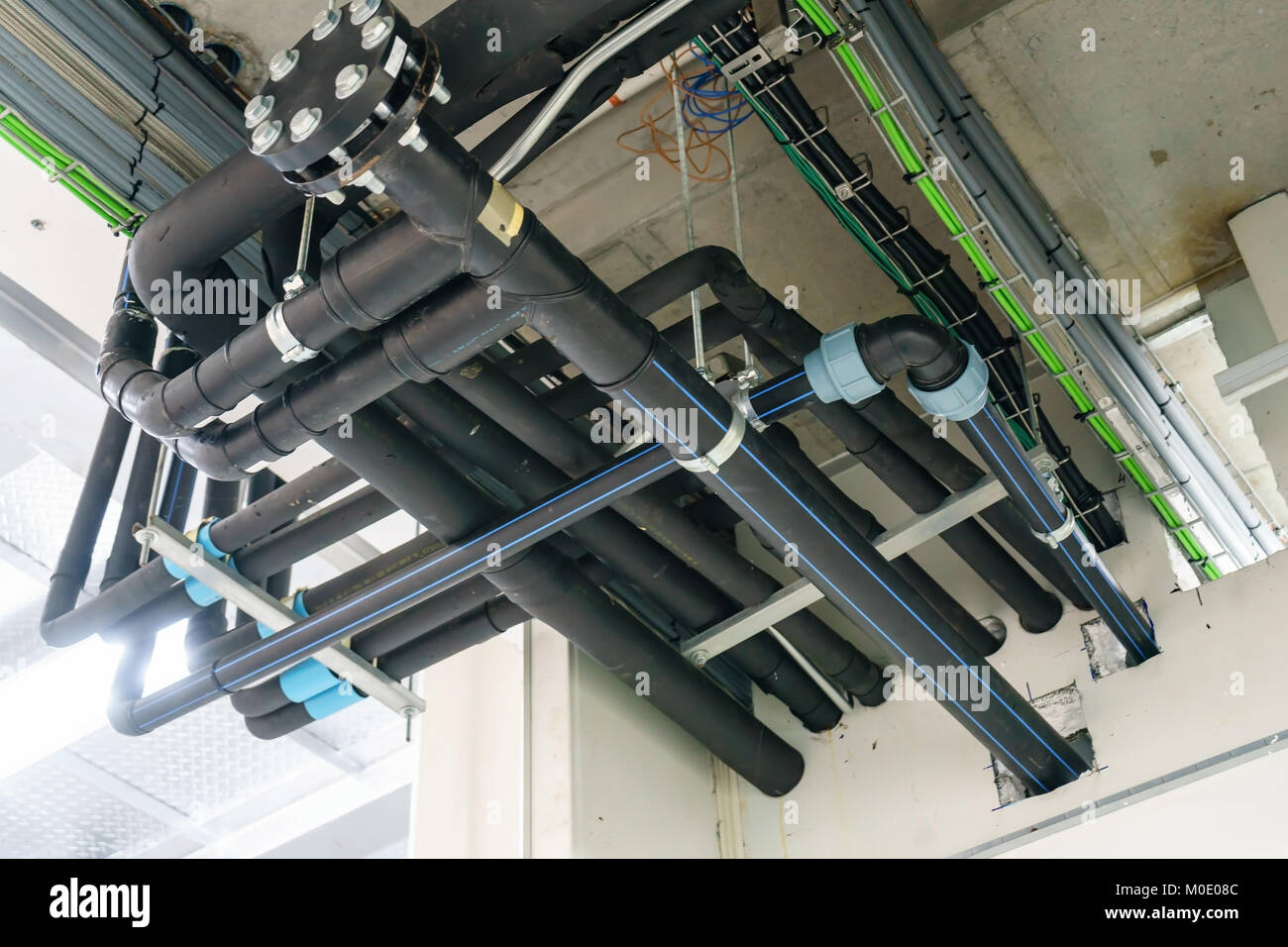 HDPE pipe installed on clamping plaster in modern building construction ...