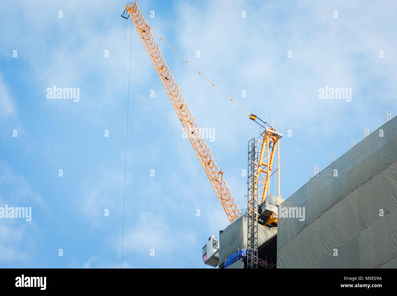 High-rise building, construction crane and building construction site ...
