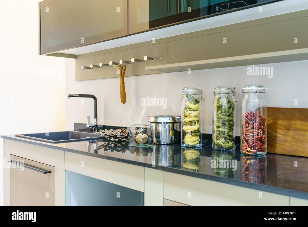 Modern kitchen interior at home with kitchenware Stock Photo - Alamy