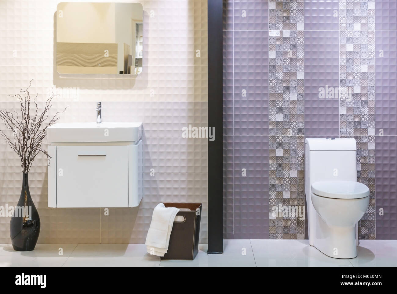 Modern spacious bathroom with bright tiles with toilet and sink. Side ...