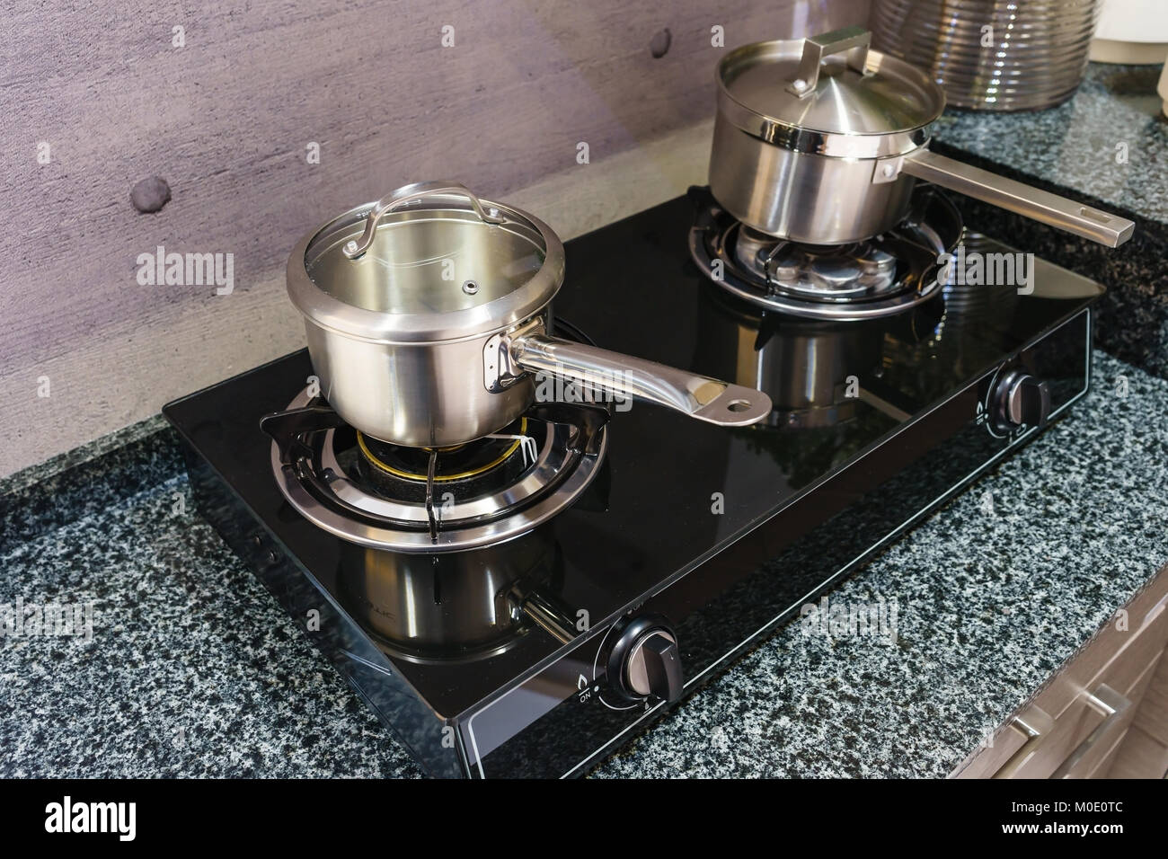 Close-up of stainless steel cooking pot on induction hob in ...