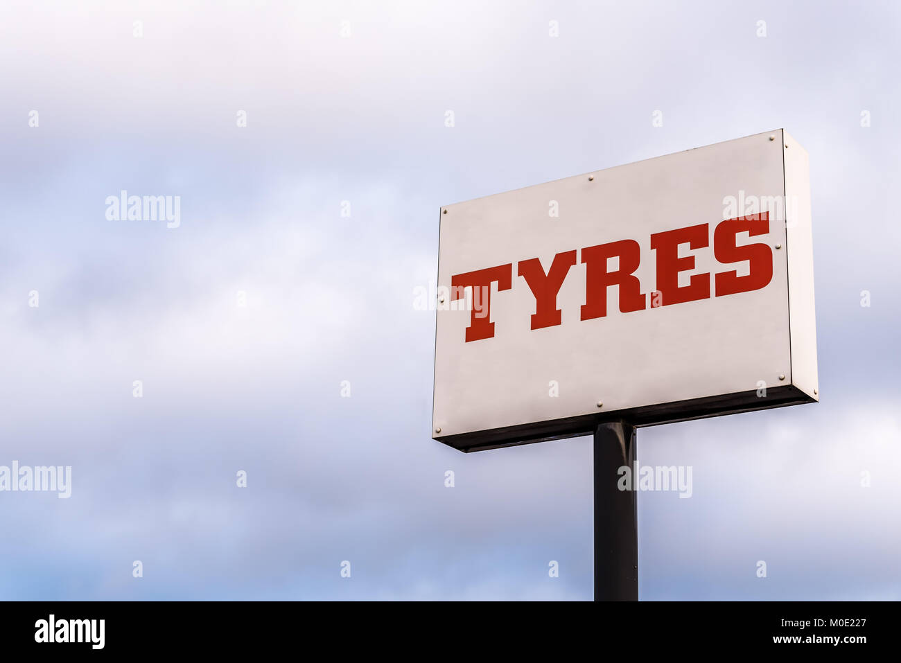 Low Angle Tyres Logo Sign over cloudy sky Stock Photo - Alamy