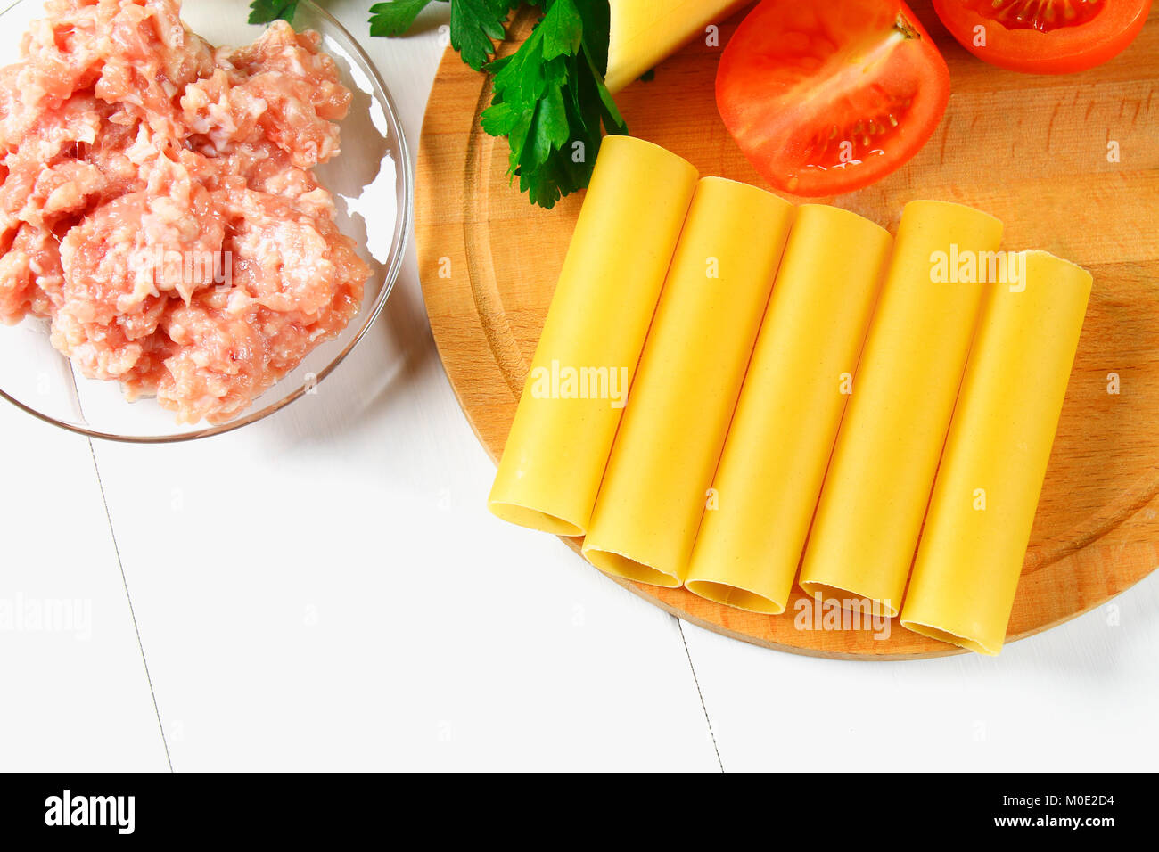 Italian pasta cannelloni. Raw tube for stuffing stuffing surrounded by ...