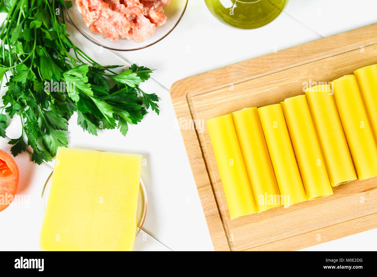 Italian pasta cannelloni. Raw tube for stuffing stuffing surrounded by ...