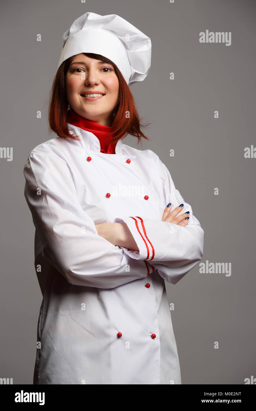 Image of cook girl in white robe and cap with crossed hands on waist ...