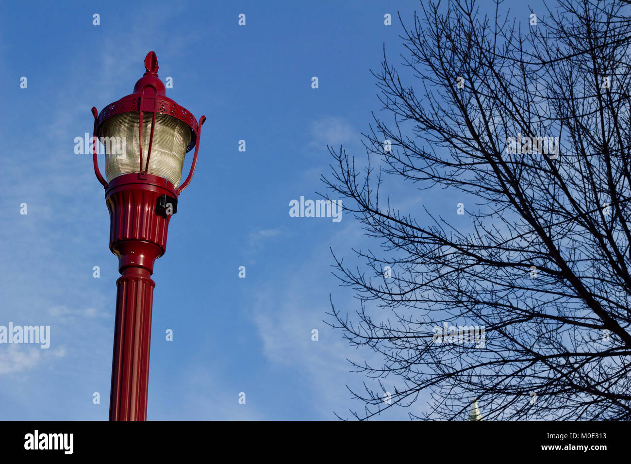 Upward view of Red city street lamp with blue sky background in fall ...