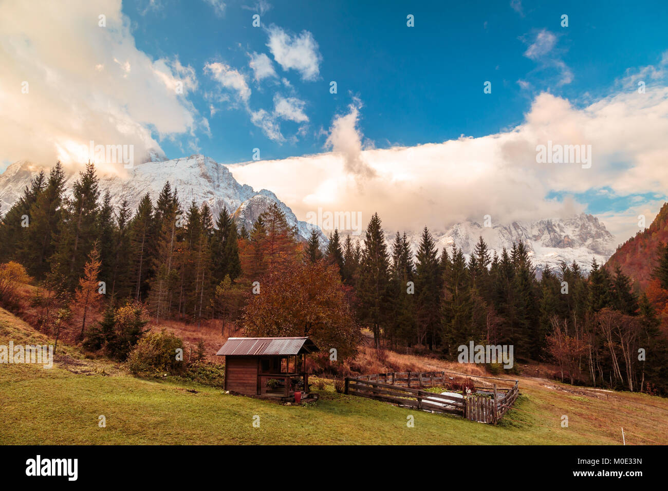 an alpine hut in the valley during a colorful sunrise Stock Photo - Alamy