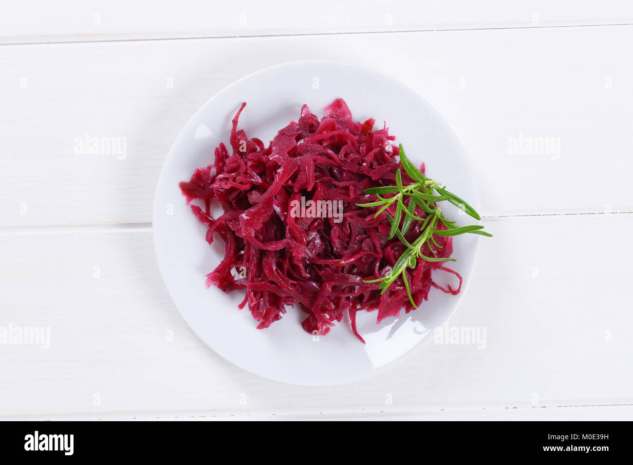 plate of pickled red cabbage on white wooden background Stock Photo - Alamy