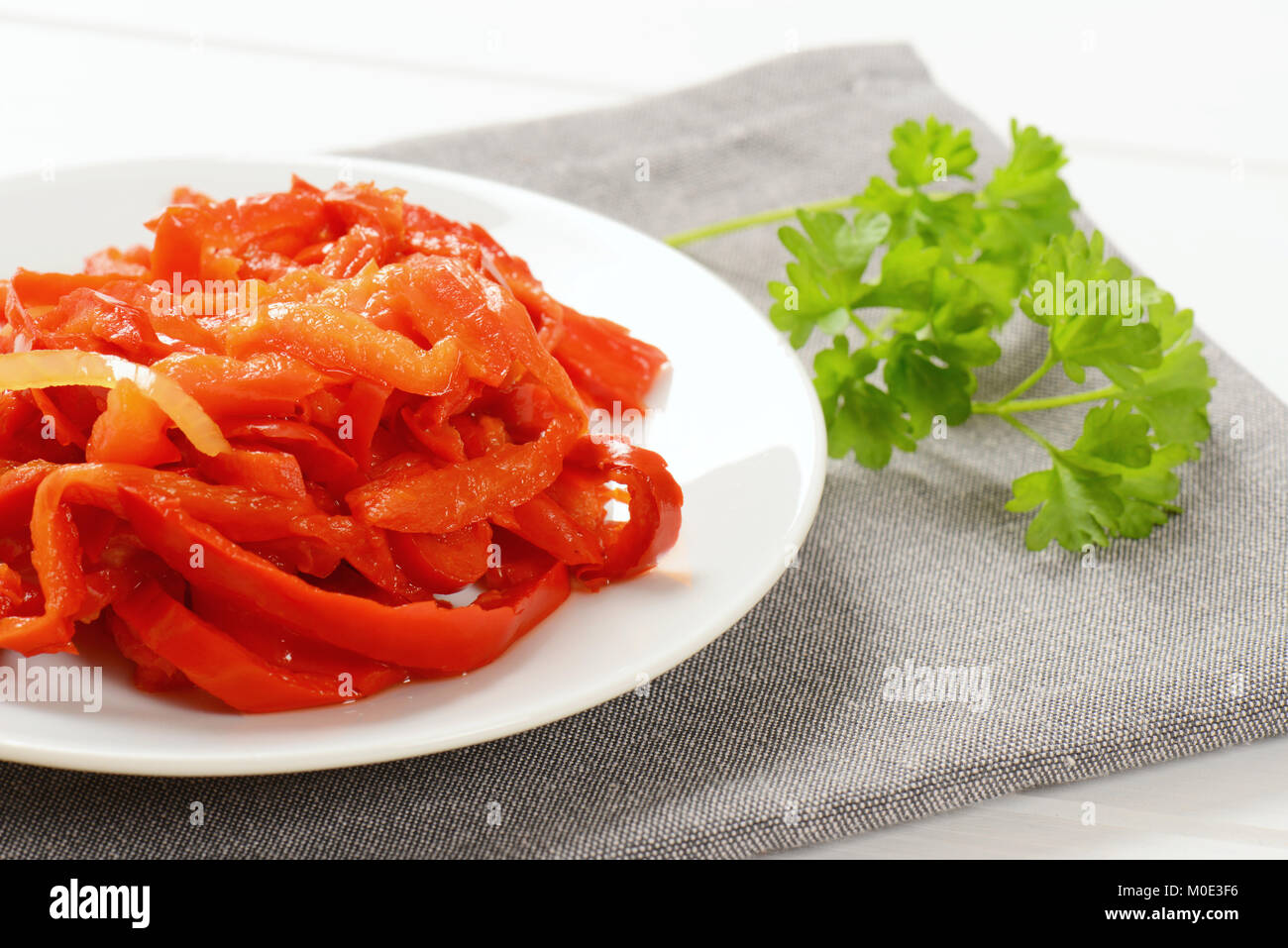 plate of pickled red peppers on grey place mat - close up Stock Photo ...
