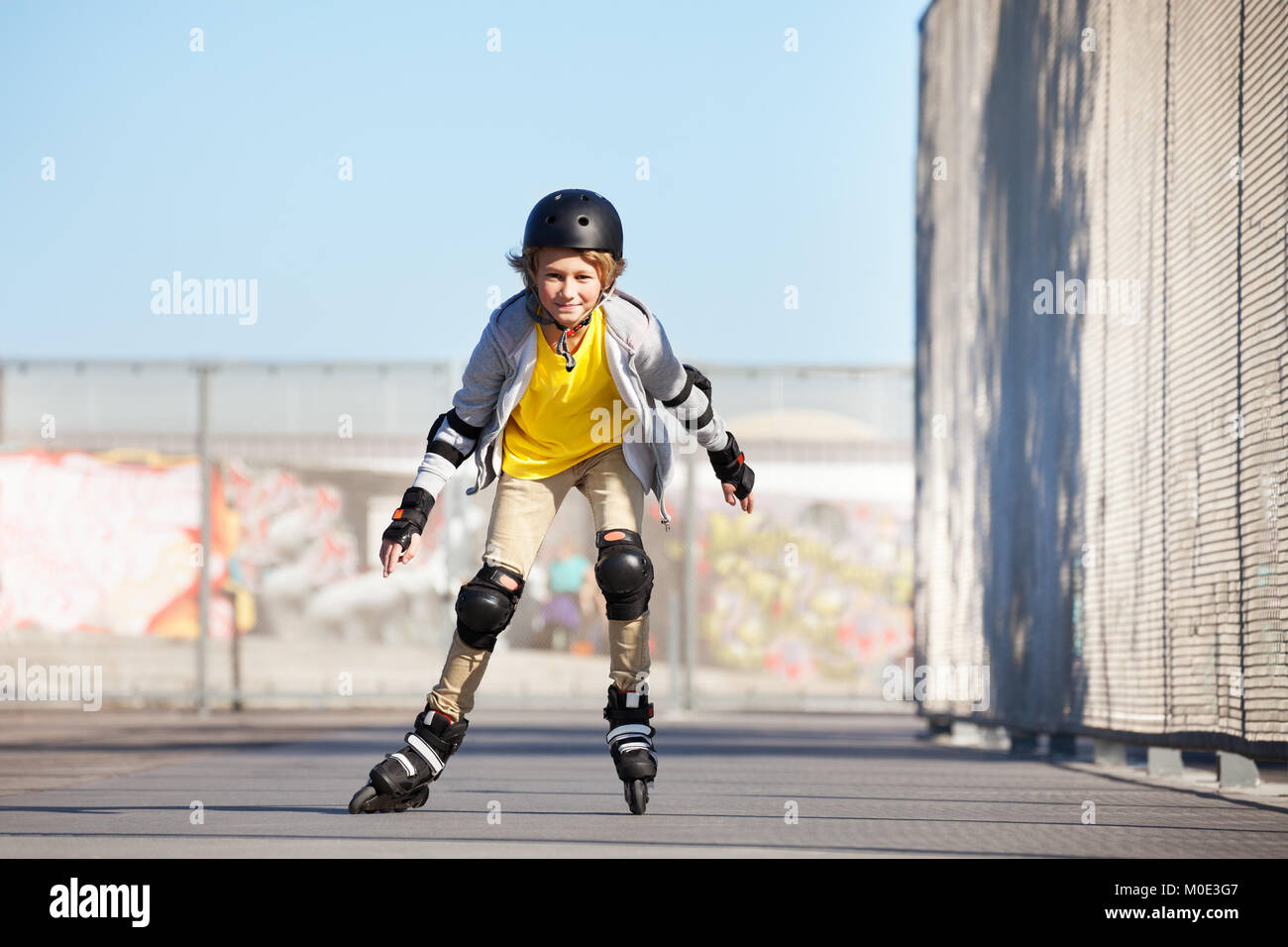 Smiling guy on roller skates in the park Stock Photo - Alamy