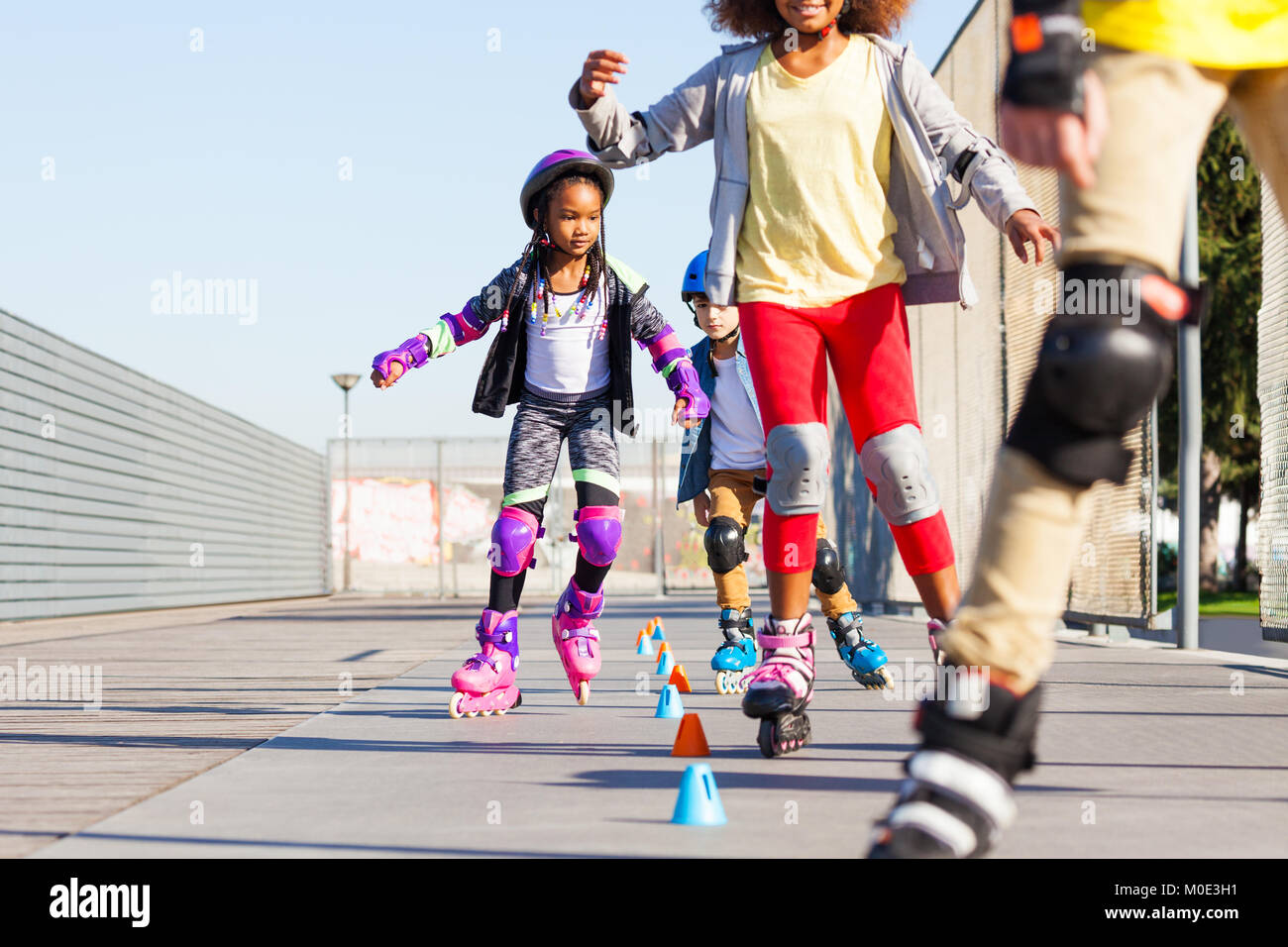 Kids learning to slalom skate with inline skates Stock Photo - Alamy