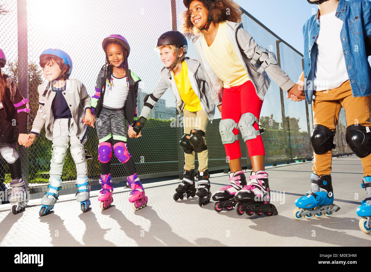 Happy friends rollerblading together at sunny day Stock Photo - Alamy