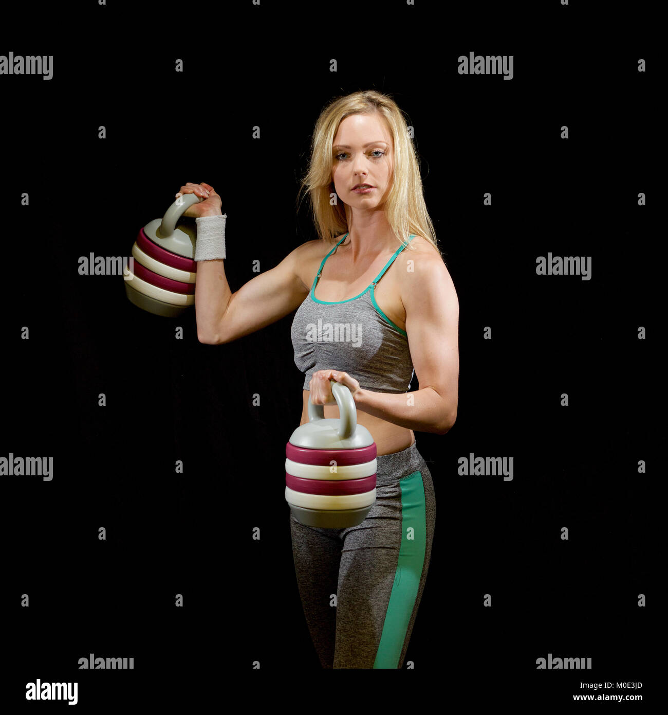 Beautiful blonde girl keeping fit against a black background Stock ...