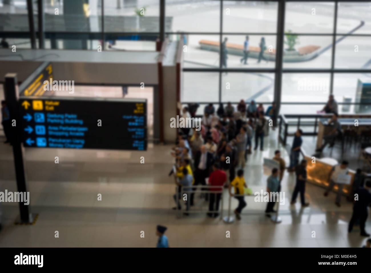 airport arrival area with people waiting - blurred abstract photo Stock ...