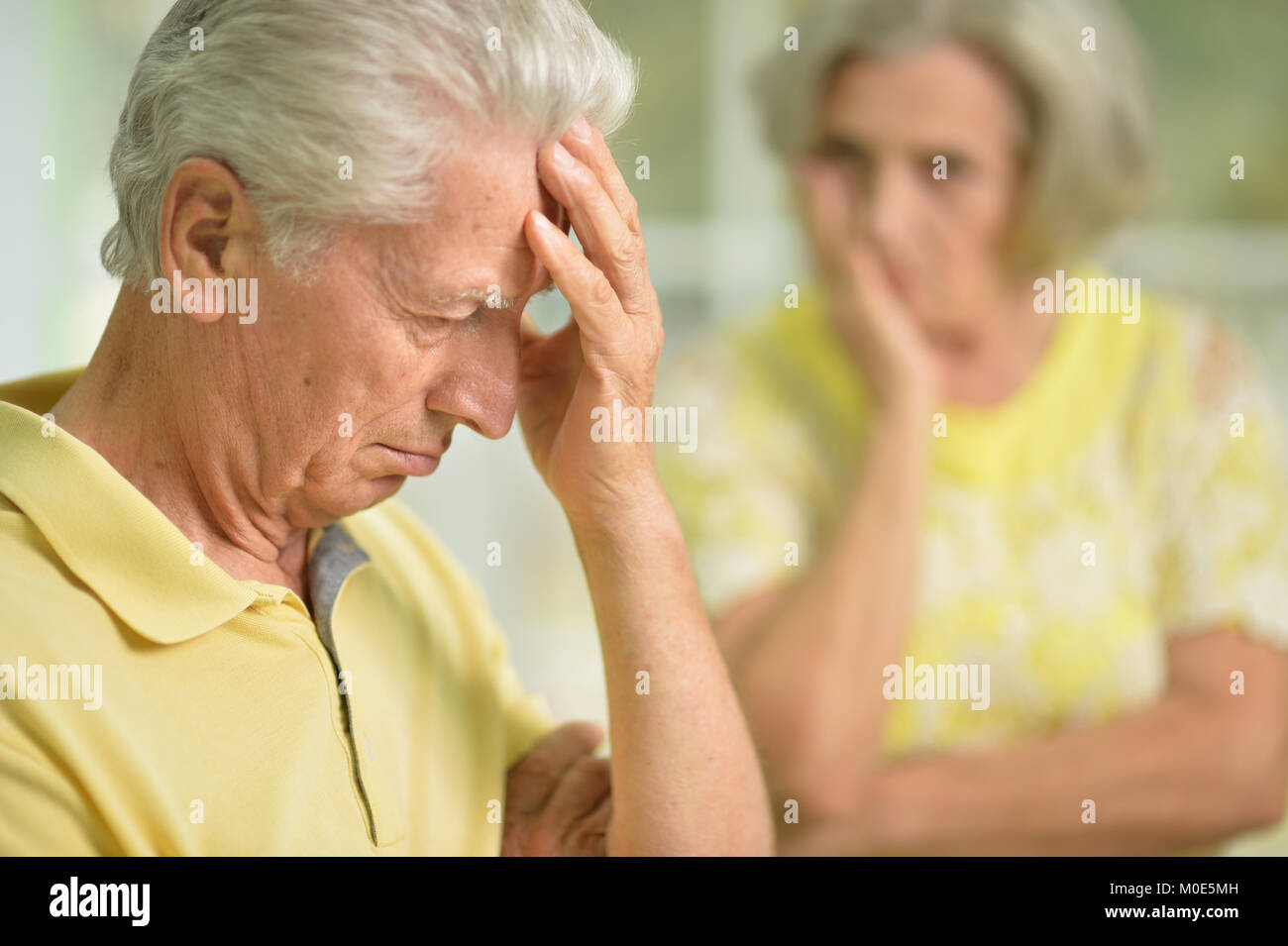 sad senior man and woman on background Stock Photo - Alamy