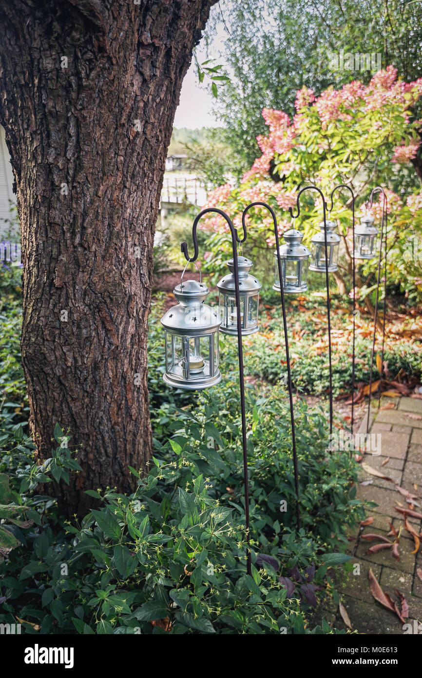 Row candlesticks along the path in the garden Stock Photo - Alamy
